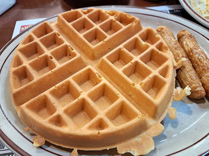 A waffle that's practically architectural – those perfect grid indentations creating little pools just waiting for butter and syrup to find their forever home.