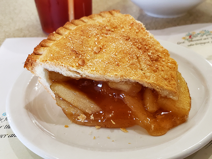 This isn't just apple pie—it's the reason elastic waistbands were invented, with golden crust barely containing its cinnamon-spiced treasure.
