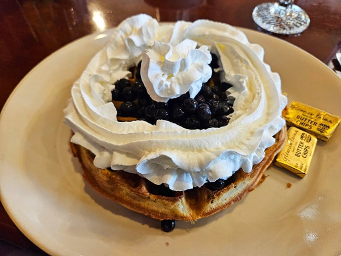 This blueberry waffle with its mountain of whipped cream isn't just breakfast—it's a celebration on a plate that makes Monday feel like Saturday.