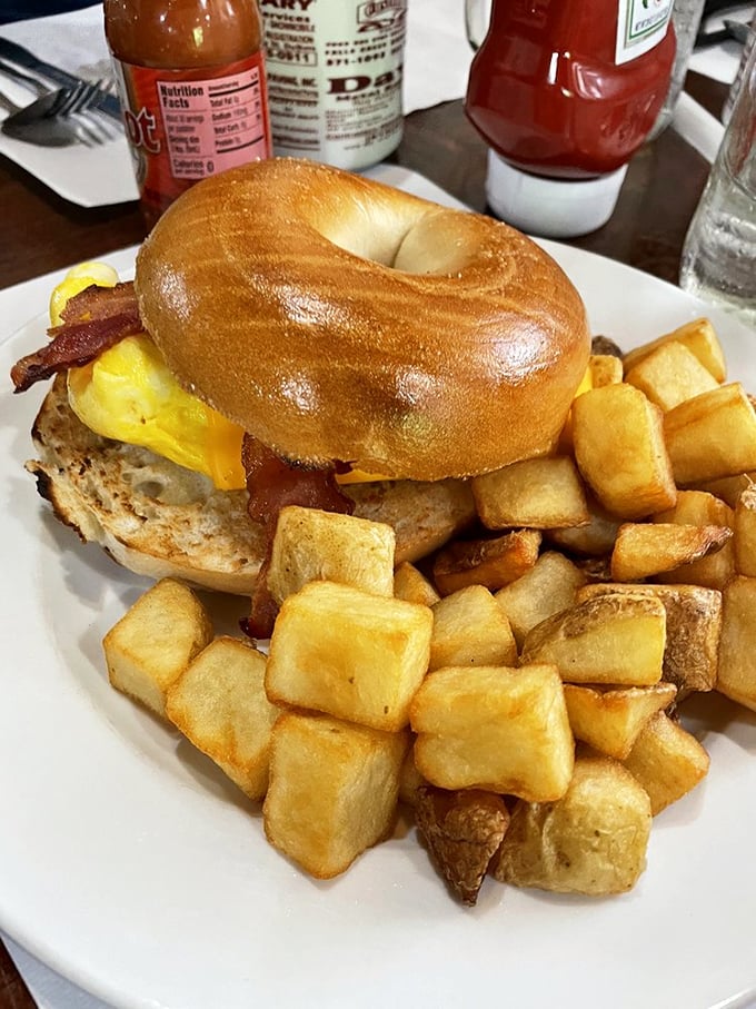This breakfast sandwich doesn't just start your day – it makes your day. The perfectly toasted bagel, melted cheese, and home fries are morning's greatest allies.