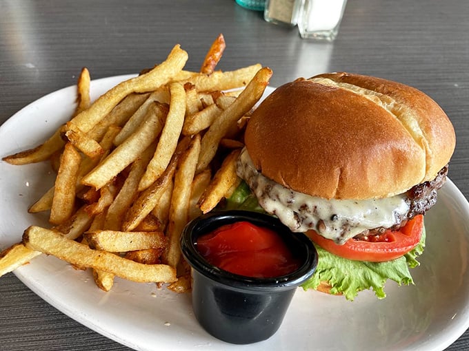 The classic American love story: a juicy burger meets hand-cut fries on a white plate. Some relationships are just meant to be.