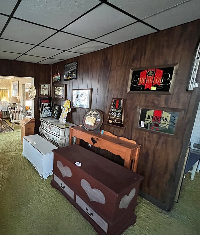 Beer signs and wooden trunks create a man-cave vibe in this corner. That heart-decorated chest probably didn't hold actual hearts… probably.