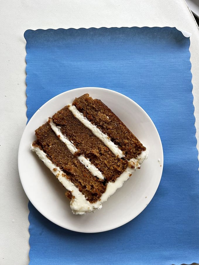 Layer upon layer of moist carrot cake with cream cheese frosting – proving vegetables can indeed be the foundation of something magical.
