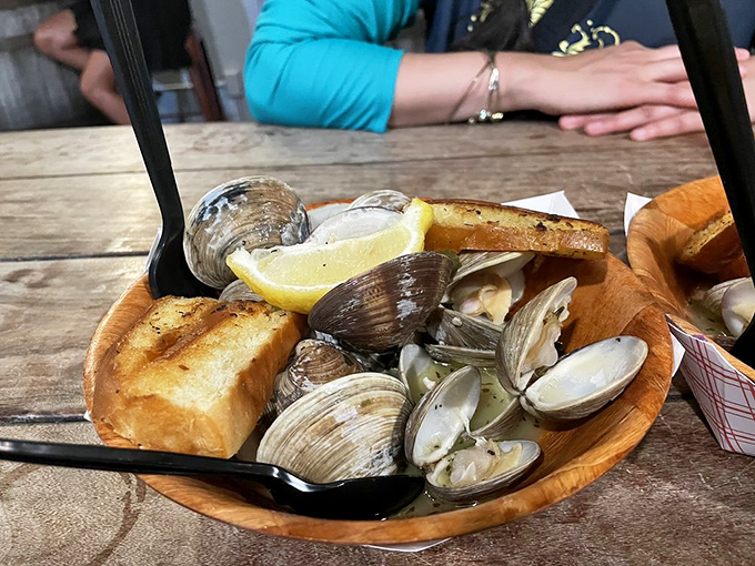 Steamed clams swimming in garlicky broth with toasted bread for dipping—nature's perfect design for turning humans into happy, messy eaters.