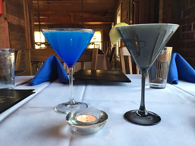 Blue cocktails that would make Sinatra proud sit elegantly on white tablecloths. That little candle isn't just for ambiance – it's witnessing liquid art.