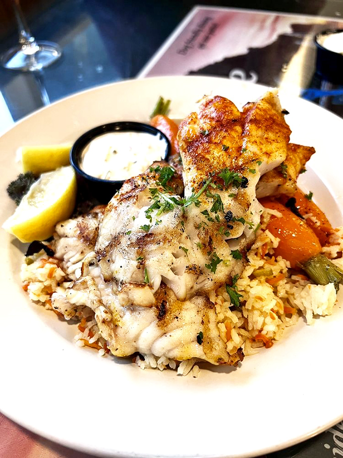 Perfectly grilled fish resting on a bed of rice like it's on vacation. The char marks tell you everything you need to know.