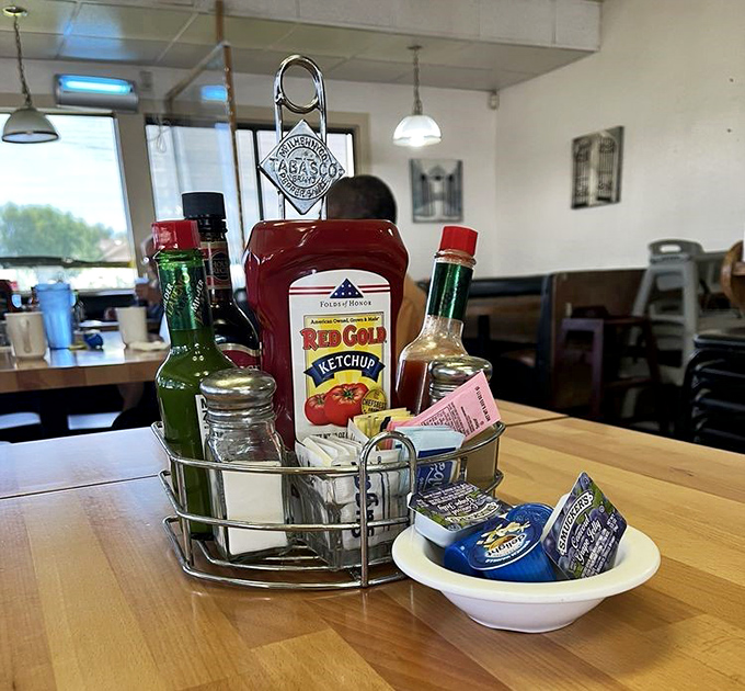 The condiment caddy—that unsung hero of diner tables everywhere. Hot sauce, ketchup, and sweeteners standing by for your personal touch.