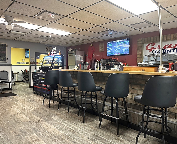 The counter seating—where breakfast philosophers gather to contemplate life's important questions, like "How do they get those home fries so crispy?"