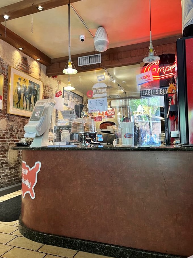 The counter at Campo's – where sandwich dreams become reality. That neon sign glows like a beacon of hope for the hungry.