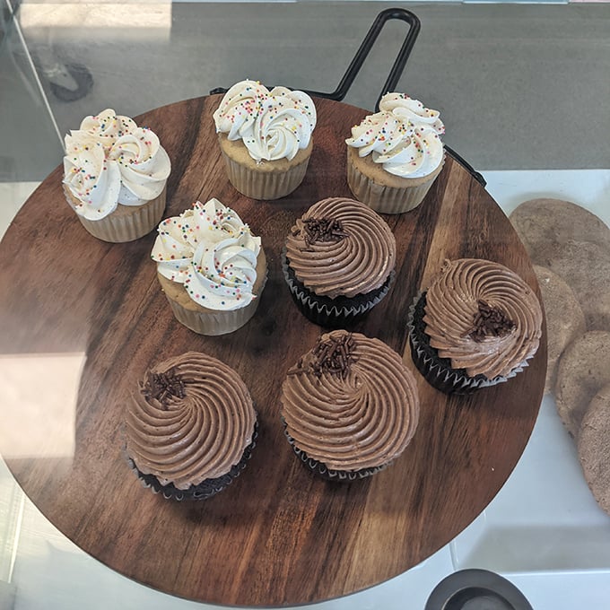 Cupcakes arranged like edible jewels on a wooden platter – the perfect single-serving indulgence when you can't commit to a whole cake.