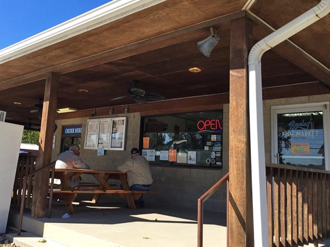 The ordering window—where culinary dreams come true with a simple "catfish fritters, please." No fancy POS systems, just good old-fashioned service.