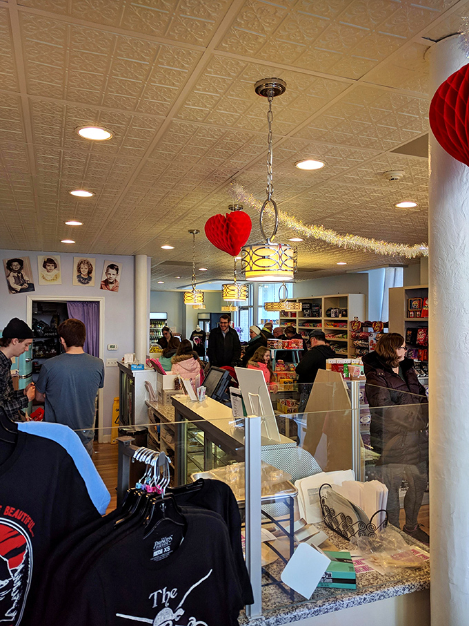 The pressed tin ceiling watches over a crowd of candy pilgrims. That red honeycomb heart isn't decoration—it's the universal symbol for "diet starts tomorrow."
