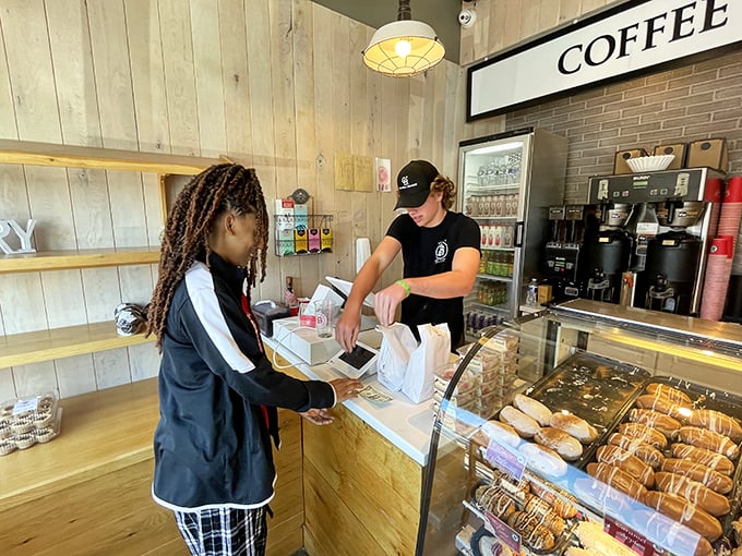 The sacred transaction: donuts passing from artisan to appreciative hands. Some religious experiences require no cathedral.