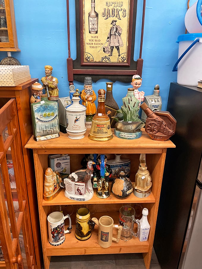 Whimsical figurines and vintage liquor decanters share shelf space in this cabinet of curiosities where nostalgia comes with a price tag.