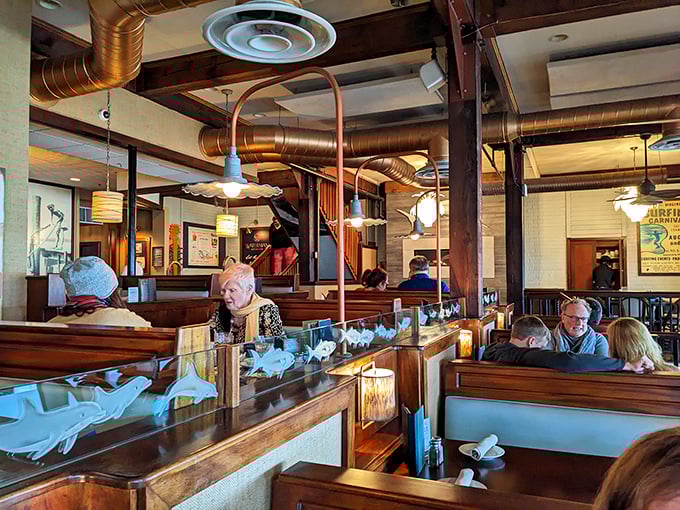 Where memories are made between bites—diners enjoying that perfect combination of good food, good company, and wooden booth comfort.
