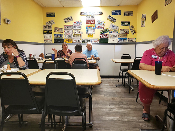 The dining room wall showcases license plates from visitors far and wide—each one a testament to food worth traveling for.