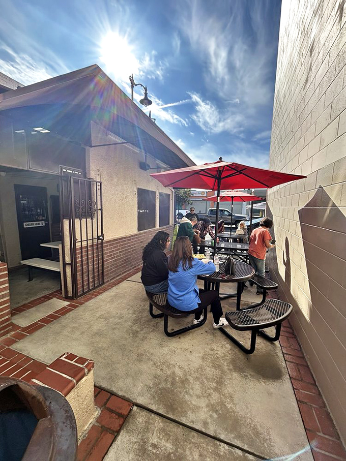 Sunshine, red umbrellas, and the promise of burritos—this patio scene is what California dreams are made of.