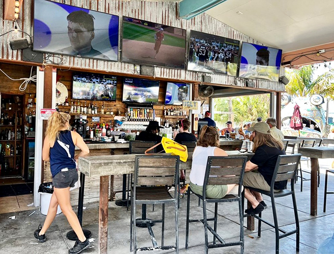 The bar scene buzzes with a mix of locals and tourists, all united in the universal language of good food and cold drinks.
