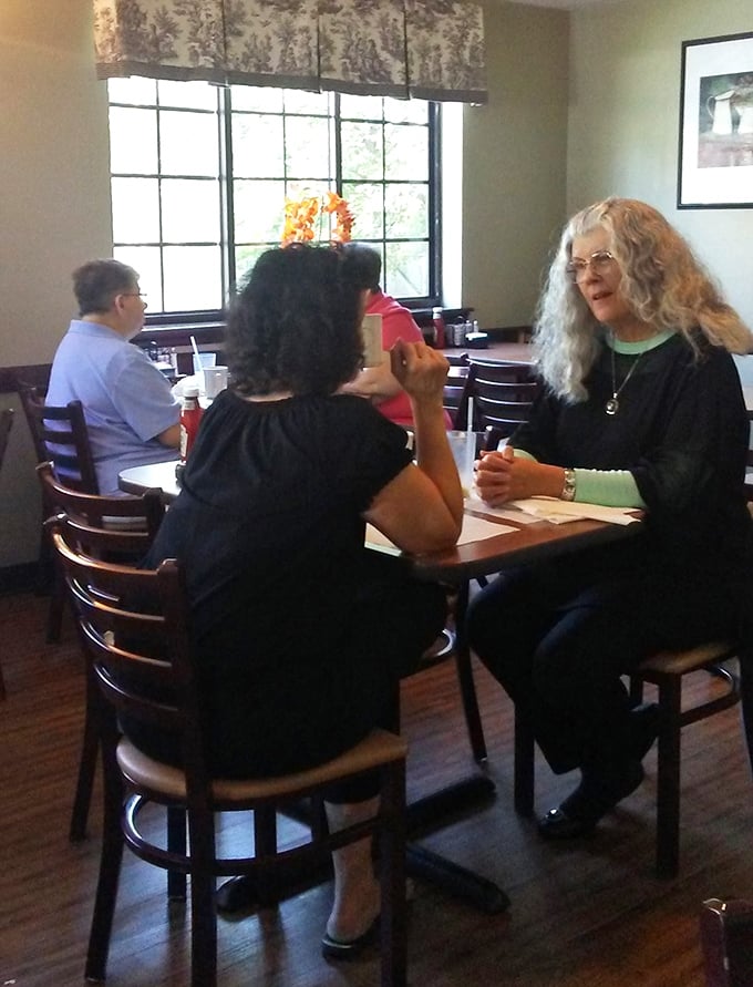 Breakfast conversations at Ida's—where coffee refills and friendly chatter flow with equal abundance and warmth.