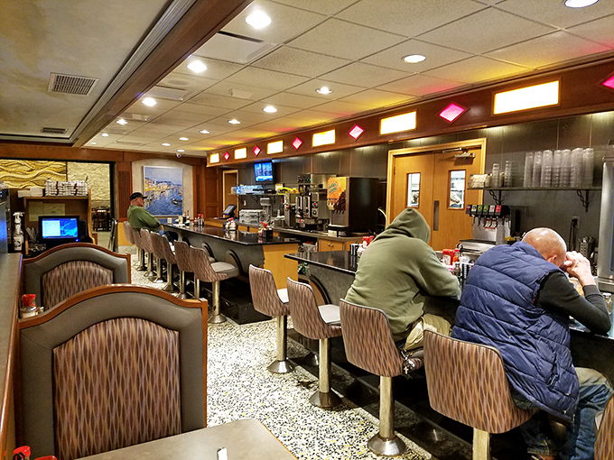 The counter seating—where diner magic happens. Where regulars become family and solo diners find community over coffee and pie.