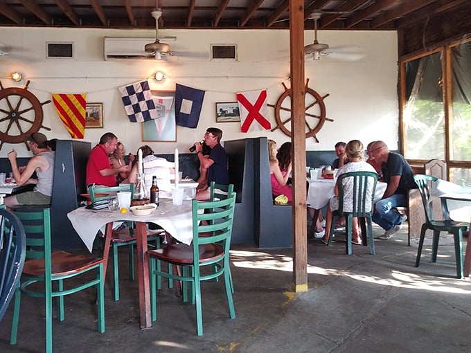 Nautical flags and ship wheels aren't kitschy decorations here—they're authentic touches in a place where the sea isn't a theme, but a way of life.