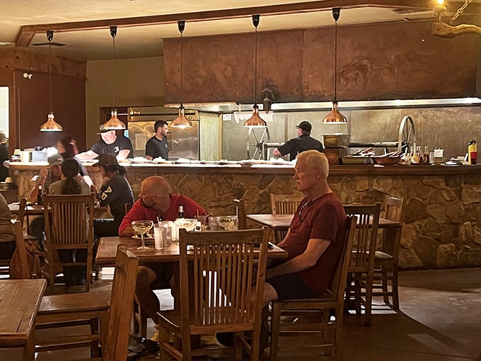 Where locals and travelers come together over exceptional food—the open kitchen design lets you watch the mesquite magic happen.