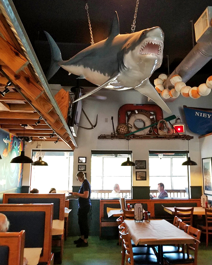 That shark isn't the only thing hanging around—diners linger too, savoring both seafood and the maritime atmosphere that surrounds them.