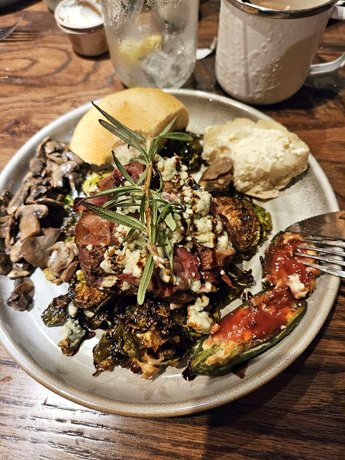 This isn't just dinner—it's a celebration on a plate. Rosemary-kissed steak, roasted vegetables, and what appears to be blue cheese crumbles form a triumphant trio.