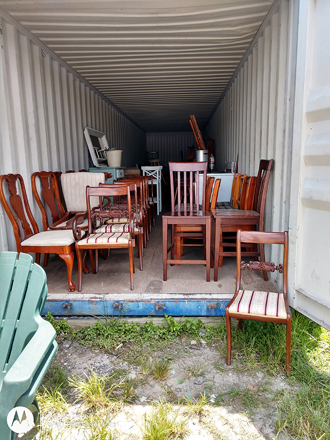 Dining chair purgatory or furniture treasure trove? These wooden seats wait patiently in their shipping container showroom for second-chance homes.