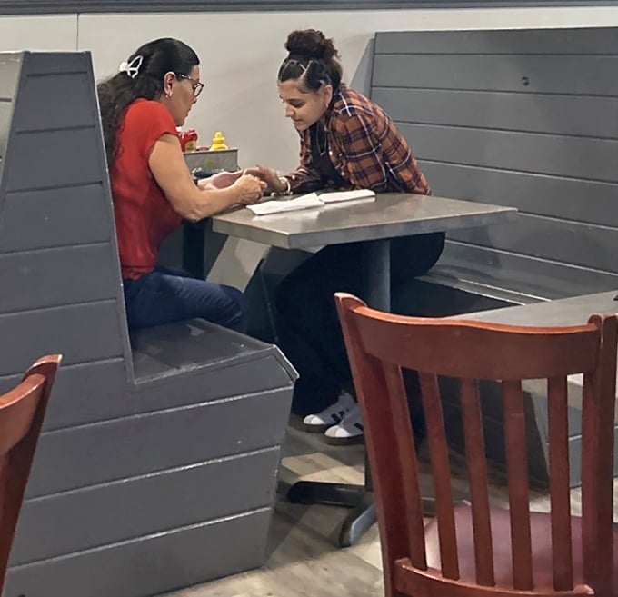 The booths offer semi-private sanctuaries where locals gather to share stories, meals, and the occasional "you've got to try this" moment.
