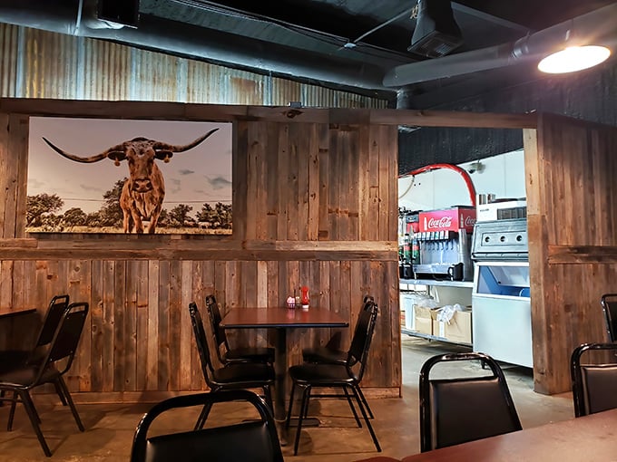 Rustic wooden walls display longhorn art—a reminder that your dinner's ancestors once roamed these very plains with considerably more attitude.