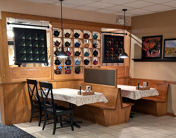 Teapots line the wall like sentinels guarding ancient brewing wisdom. This cozy nook feels like you've stumbled into the quiet heart of Amish hospitality.