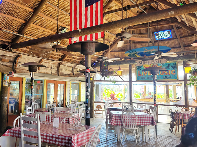 Under that thatched roof, with American flags and fishing memorabilia, you're not just dining—you're participating in Florida's coastal heritage.