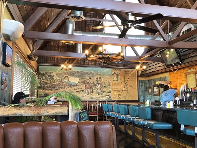 The dining room where Route 66 nostalgia meets actual good food, under exposed beams that have witnessed countless satisfied sighs.