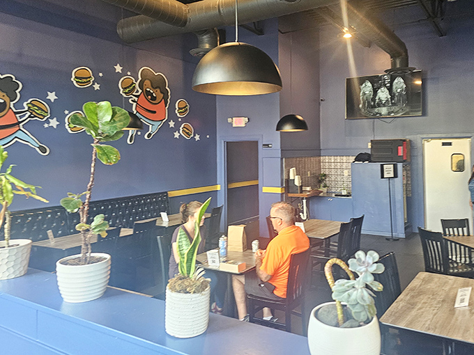 Plants add a touch of green to the blue interior, as if to say, "Yes, we know you're not here for salad, but we appreciate balance."