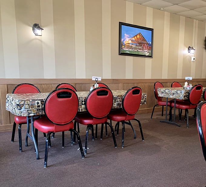 Red chairs wait patiently for the next round of hungry pilgrims. This isn't just eating out – it's communal therapy with carbs.