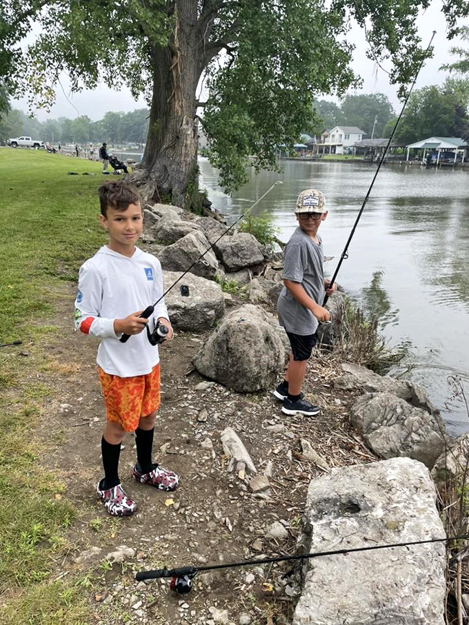Future fishing champions testing their patience and skills along the rocky shoreline – creating memories that will outlast whatever's in their tackle box.