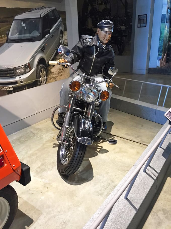 This motorcycle display features a lifelike figure ready for the open road, capturing that universal feeling of freedom that comes with two wheels and an open throttle.