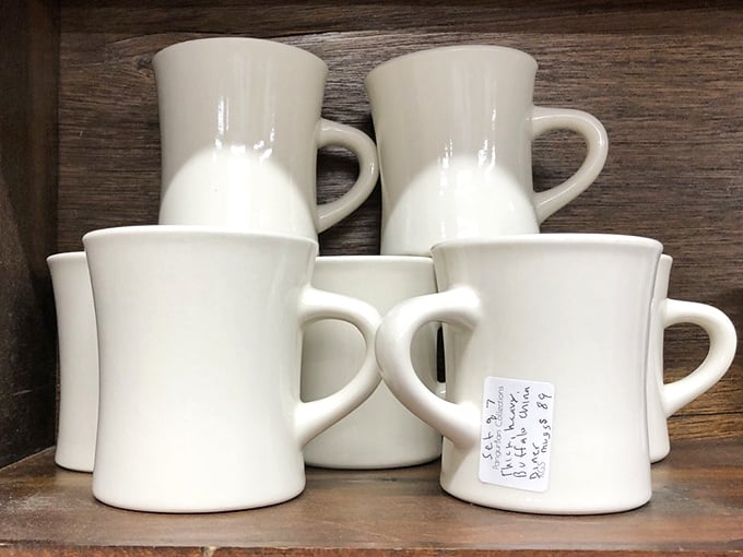 Restaurant-grade mugs stand at attention, ready for their next coffee service. Diners across America once served endless refills in these sturdy white soldiers.