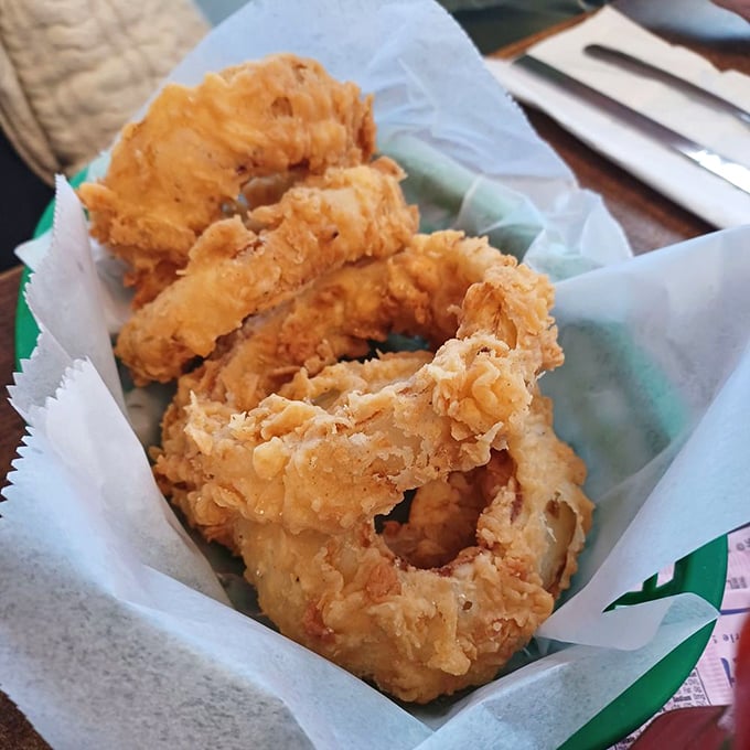 Golden-fried onion rings that shatter with each bite – the perfect marriage of crispy exterior and sweet, tender onion.