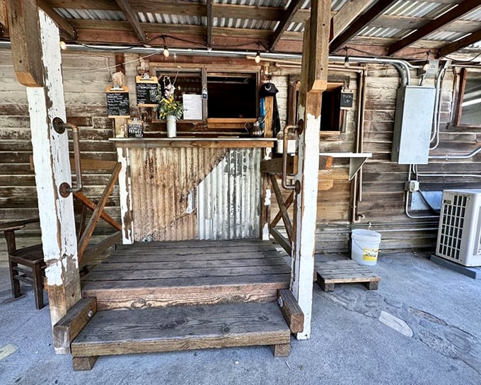 This isn't just an ordering window—it's a portal to happiness. The weathered wood and corrugated metal speak to simpler times when food was honest.
