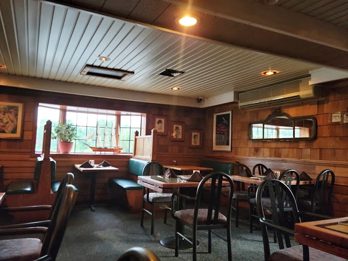 Cozy booths and wood-paneled walls make this dining room feel like the captain's quarters of a luxury yacht—minus the seasickness.