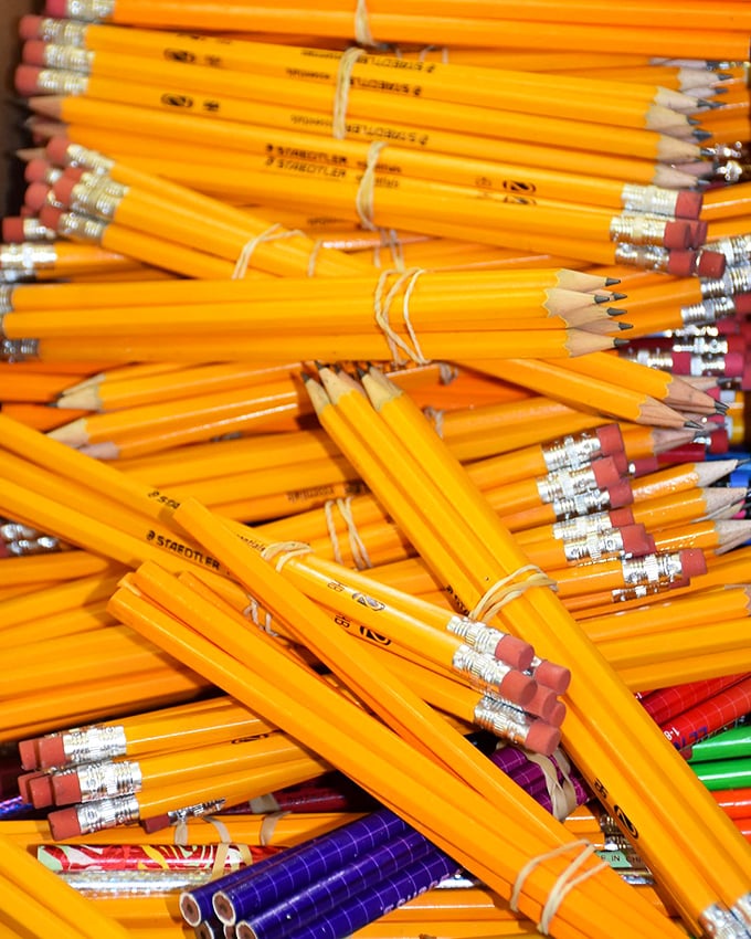 A sea of #2 pencils bundled like tiny yellow rafts. School supply shopping without breaking the bank—parents rejoice!