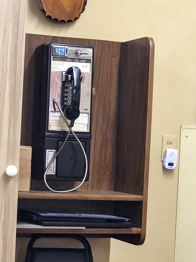 The payphone booth—a charming relic from when "texting" meant passing notes in class. Some traditions are worth preserving.