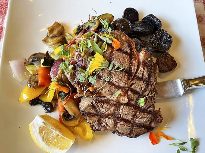 Even landlubbers find happiness here—a perfectly grilled ribeye that proves The Old Clam House respects protein in all its glorious forms.