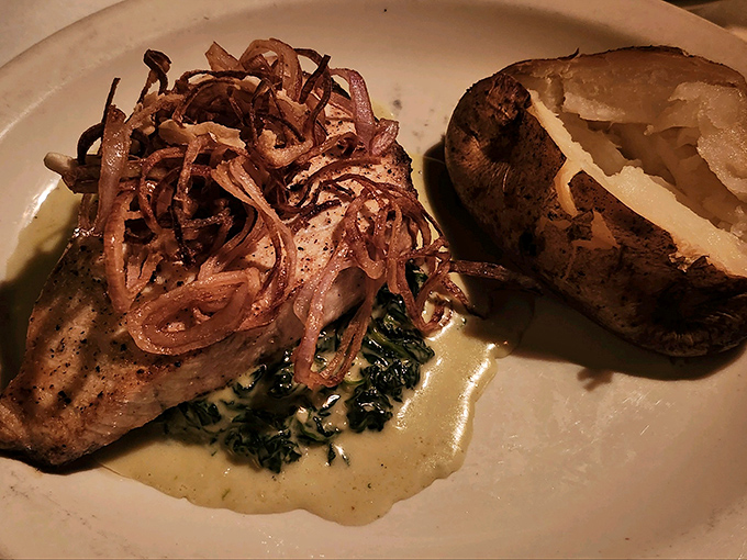 This isn't just salmon—it's a love letter to simplicity. Perfectly seared fish resting on wilted greens with crispy shallots that add textural jazz hands.