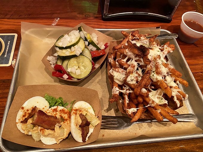 These loaded fries aren't just a side dish—they're a main event masquerading as an accompaniment, complete with melty cheese and toppings.