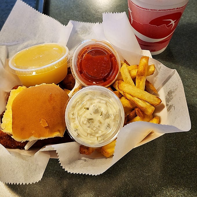 A seafood feast laid bare – tartar sauce, cocktail sauce, and applesauce standing by like loyal sidekicks to the crispy main characters.