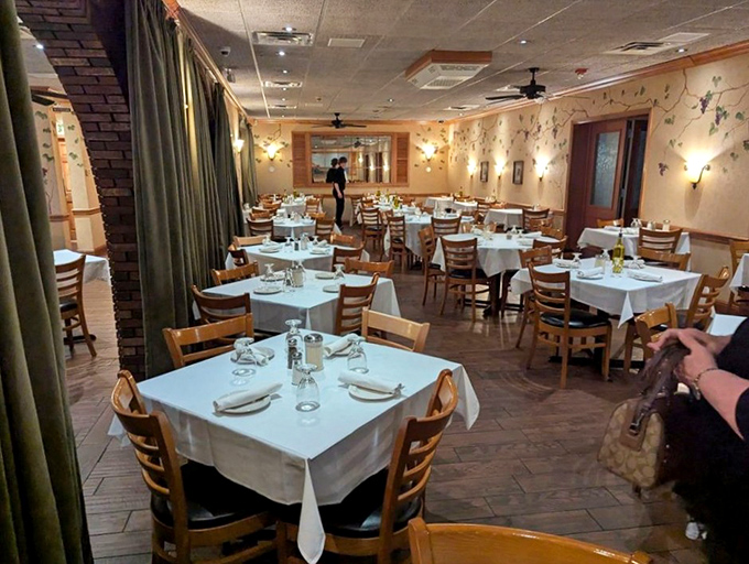 White tablecloths, wooden chairs, and vine-painted walls—the holy trinity of Italian restaurant decor that instantly makes you feel like family.