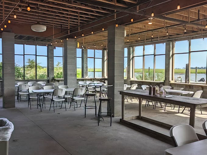 Modern meets rustic in this newer seating area, where floor-to-ceiling windows frame the marshland views like living paintings.